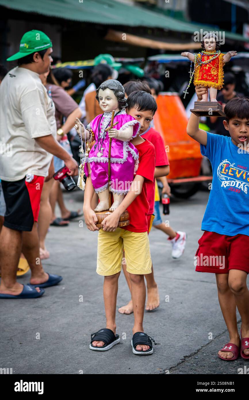 Filipino people celebrate an annual religious festival with a parade ...
