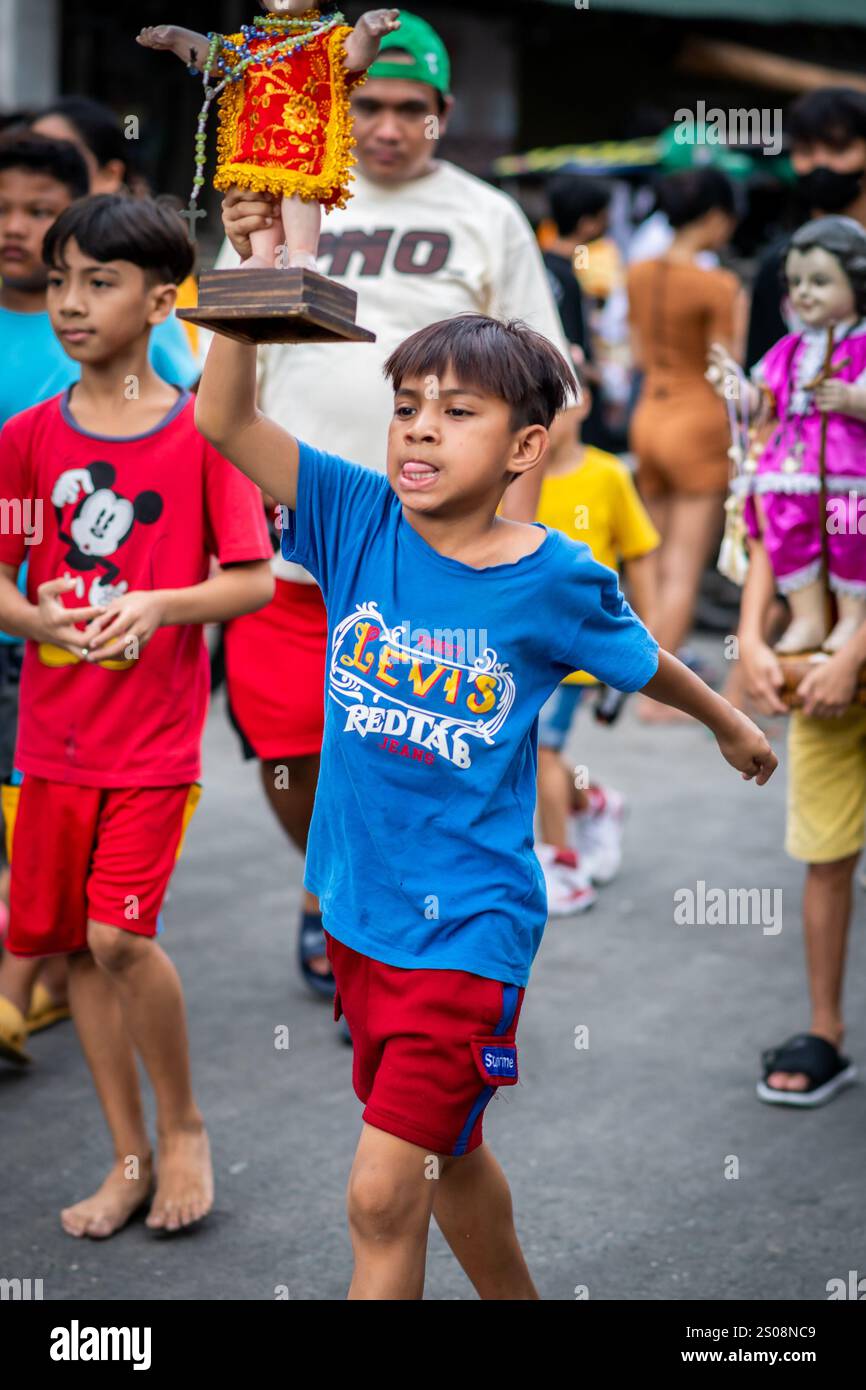 Filipino people celebrate an annual religious festival with a parade ...