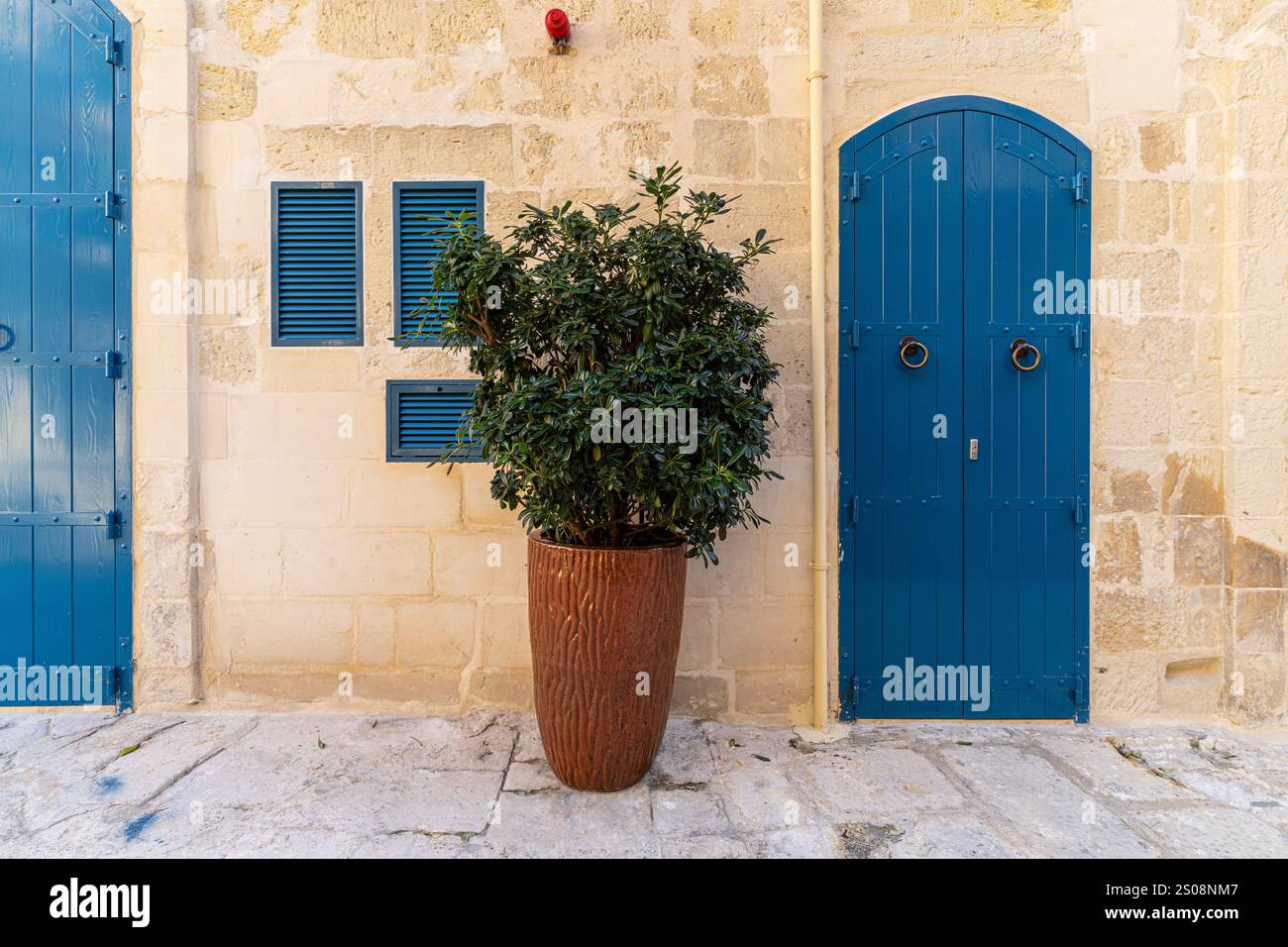 Traditional house detail in Malta. Limestone yellow bricks and colorful ...