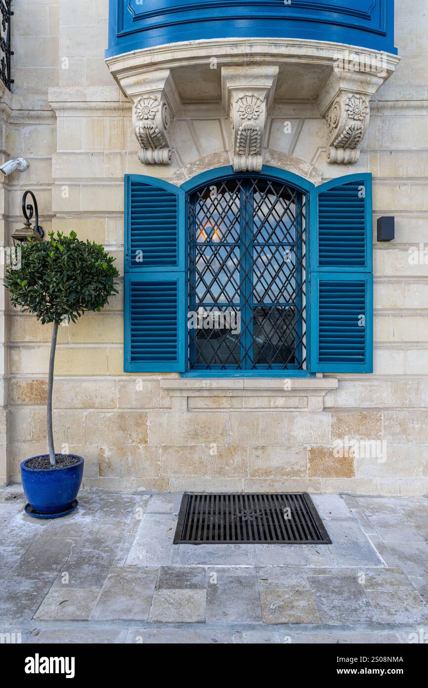 Traditional house detail in Malta. Limestone yellow bricks and colorful ...