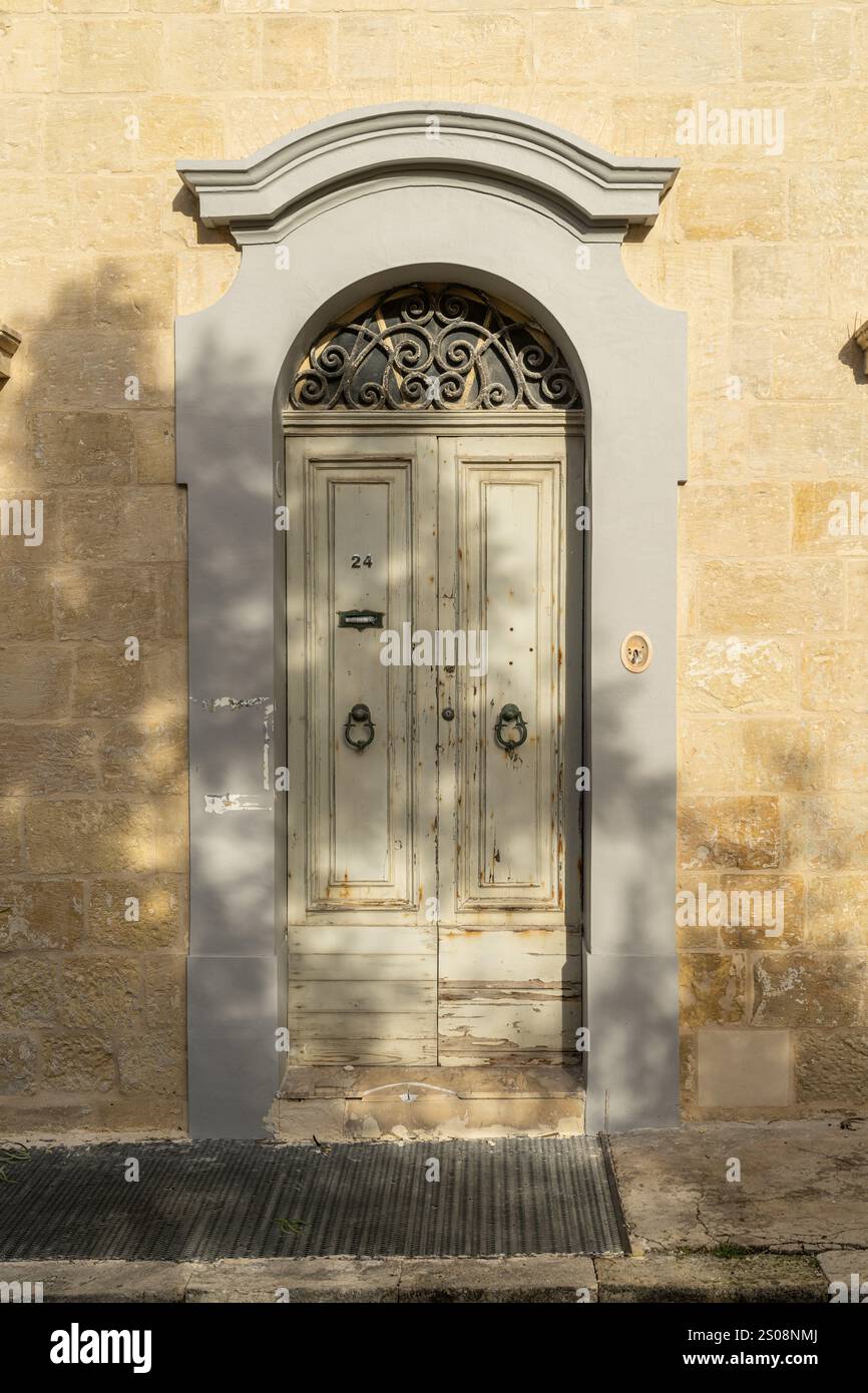 Traditional house detail in Malta. Limestone yellow bricks and colorful ...