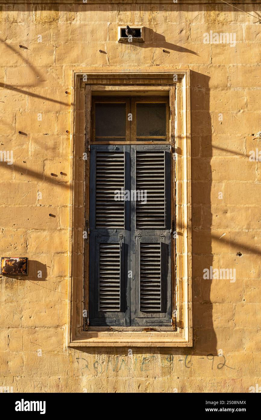 Traditional house detail in Malta. Limestone yellow bricks and colorful ...