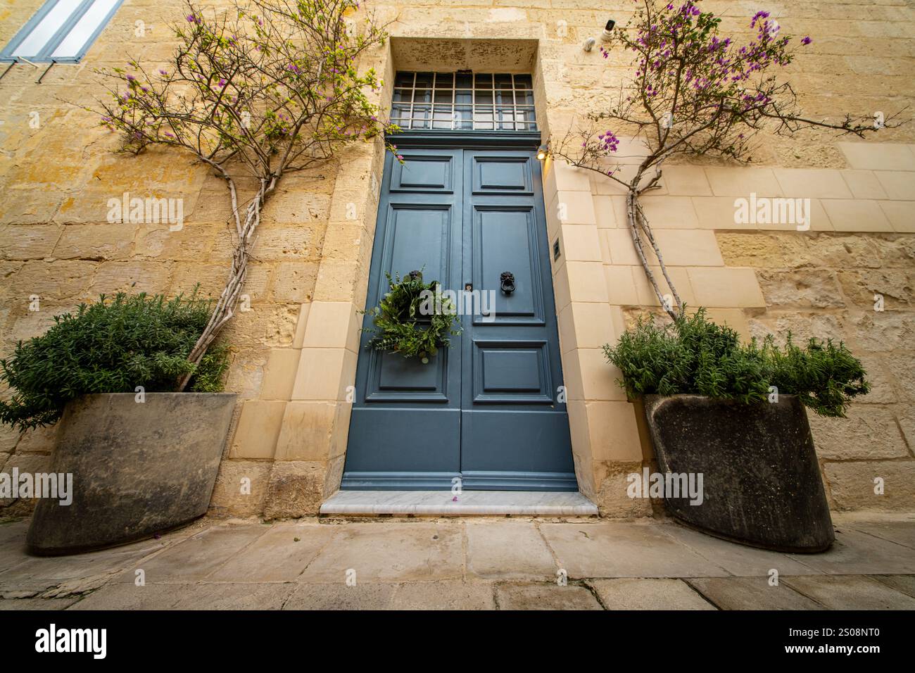 Traditional house detail in Malta. Limestone yellow bricks and colorful ...