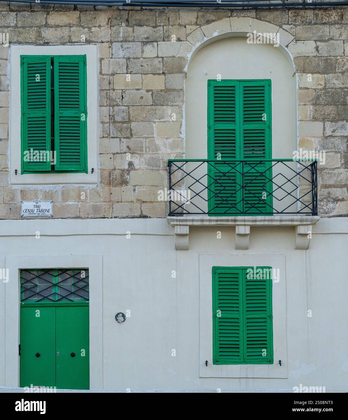 Traditional house detail in Malta. Limestone yellow bricks and colorful ...
