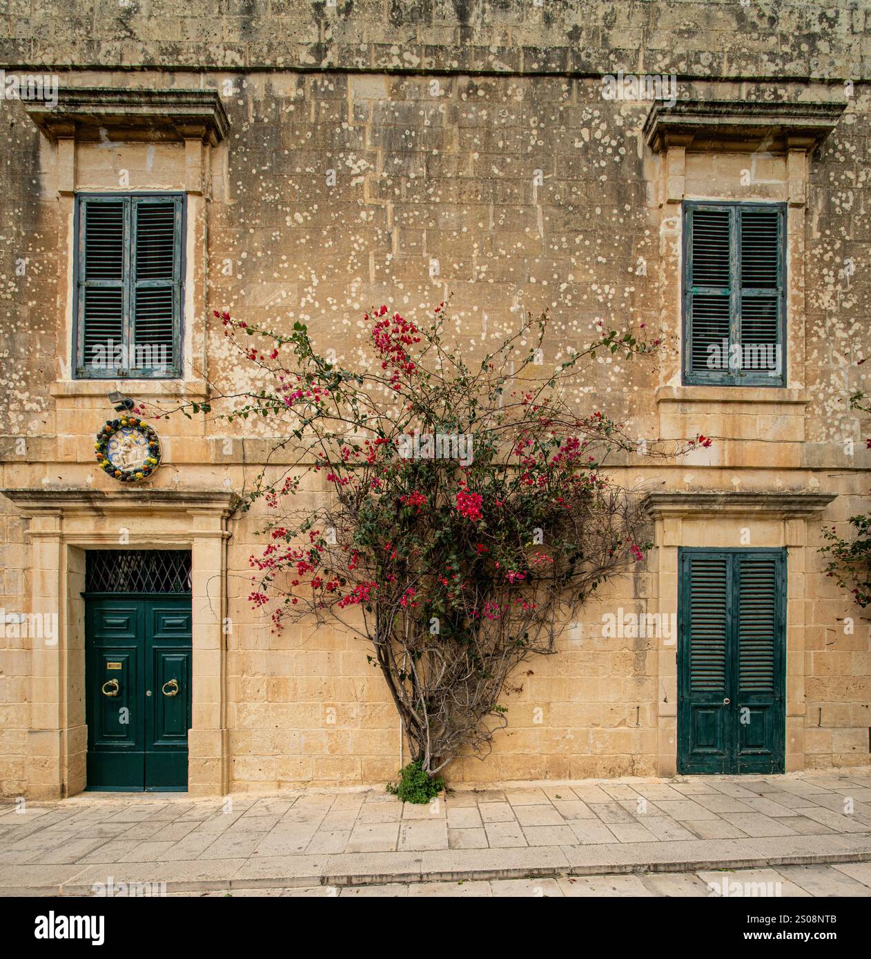 Traditional house detail in Malta. Limestone yellow bricks and colorful ...