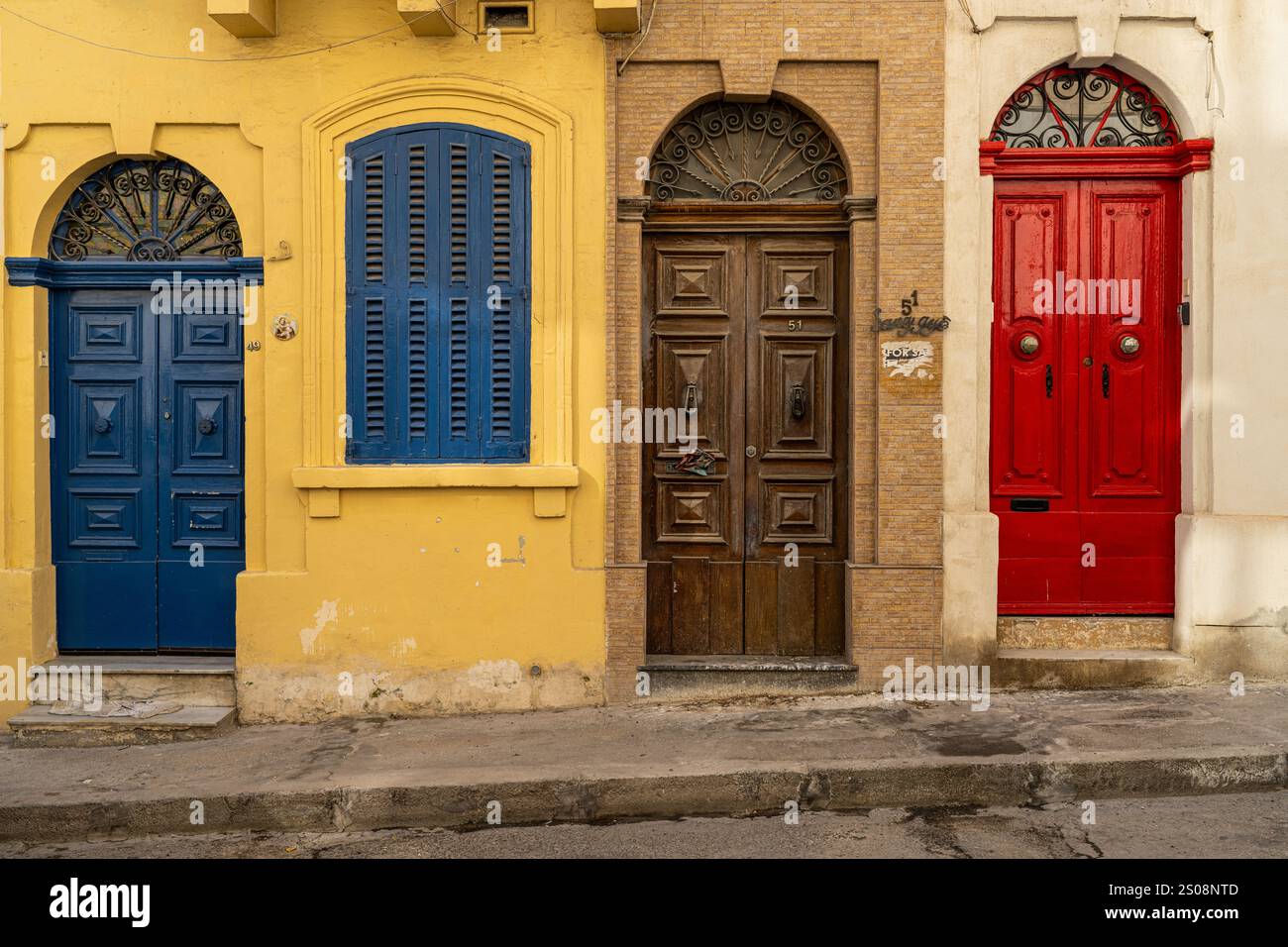 Traditional house detail in Malta. Limestone yellow bricks and colorful ...