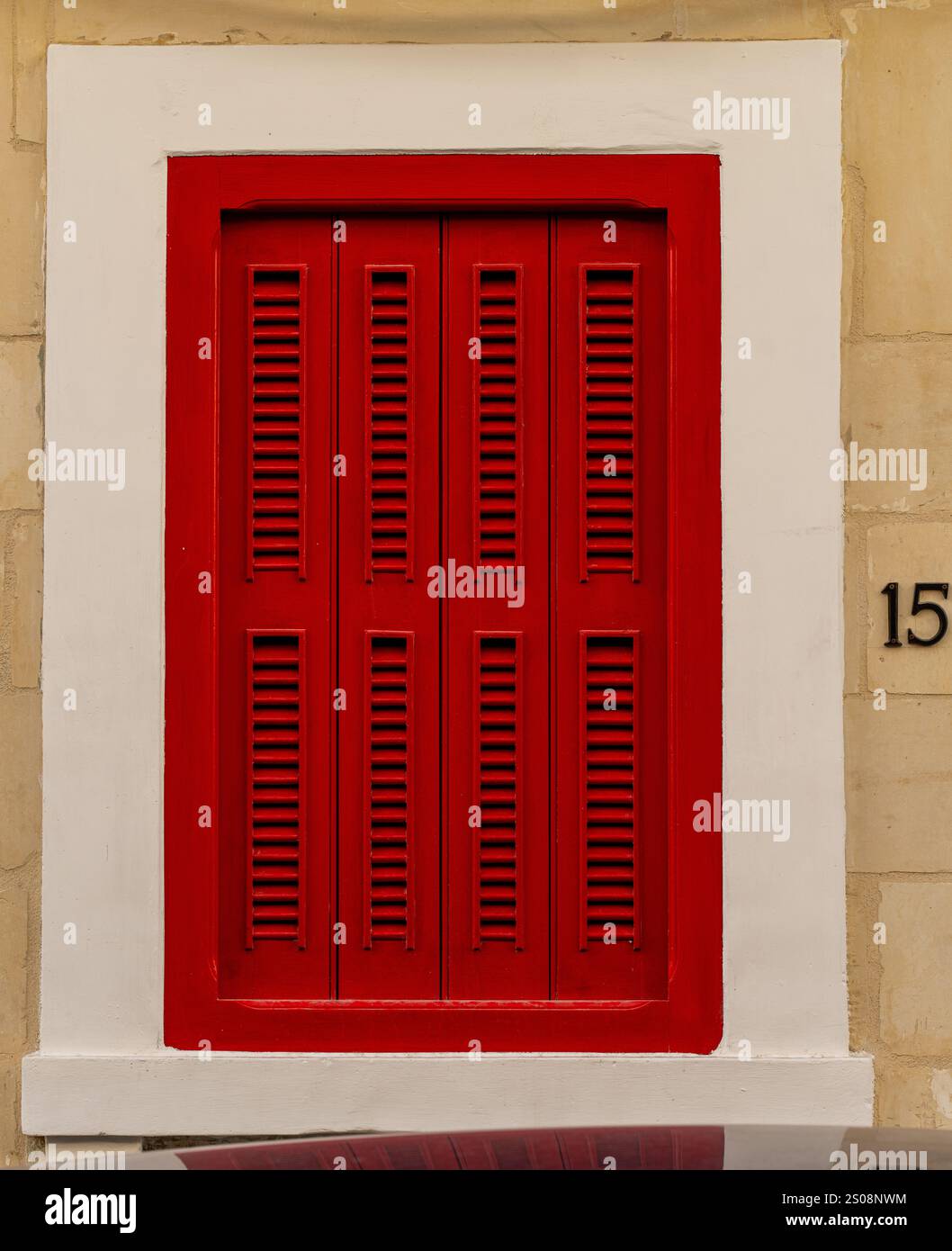 Traditional house detail in Malta. Limestone yellow bricks and colorful ...