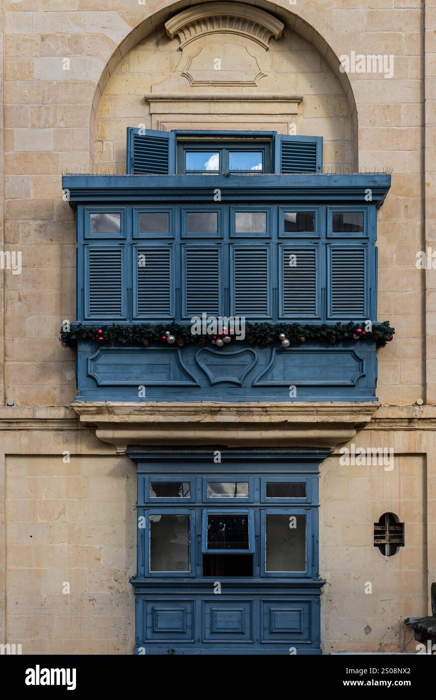 Traditional house detail in Malta. Limestone yellow bricks and colorful ...