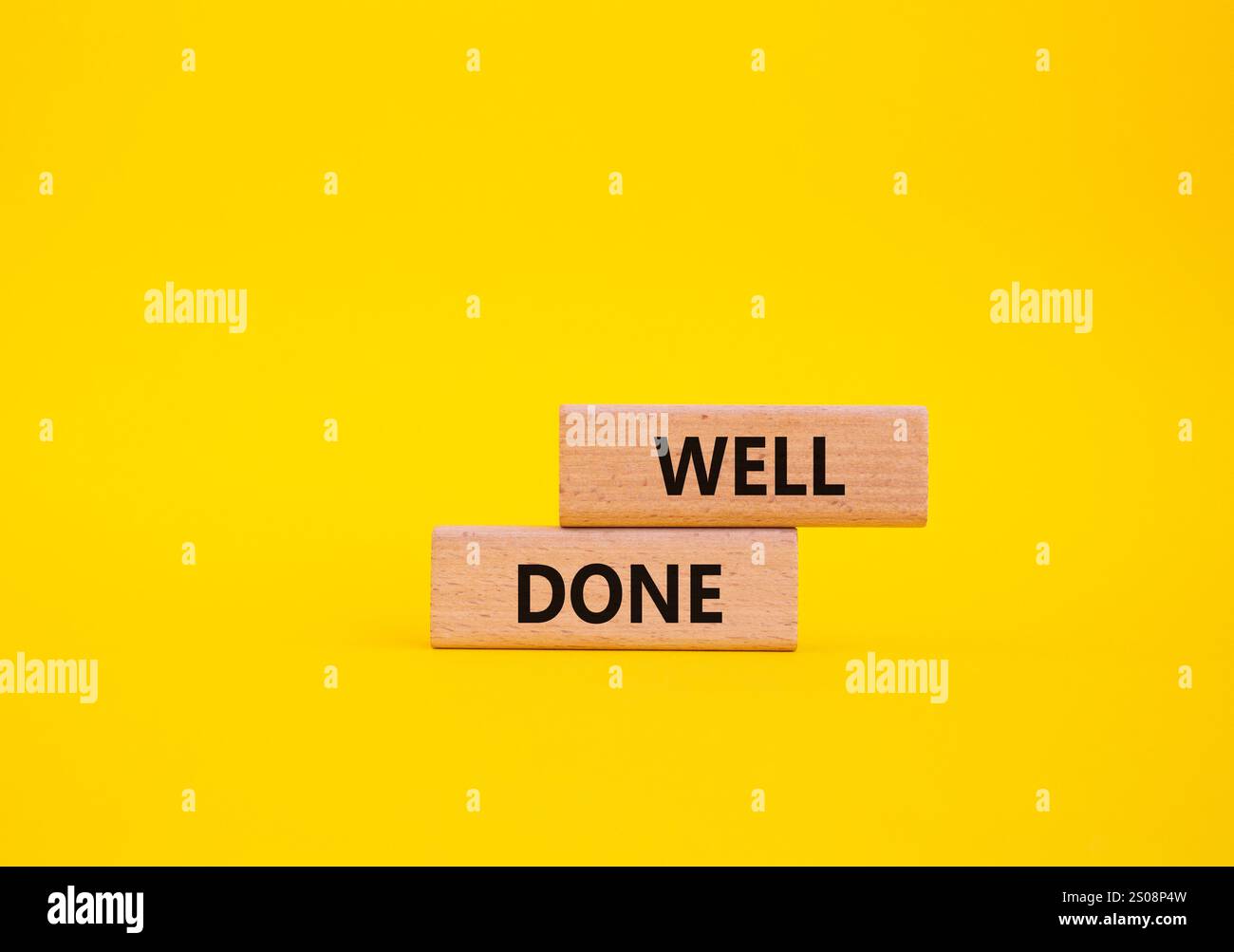 Well done symbol. Wooden blocks with words Well done. Beautiful yellow ...