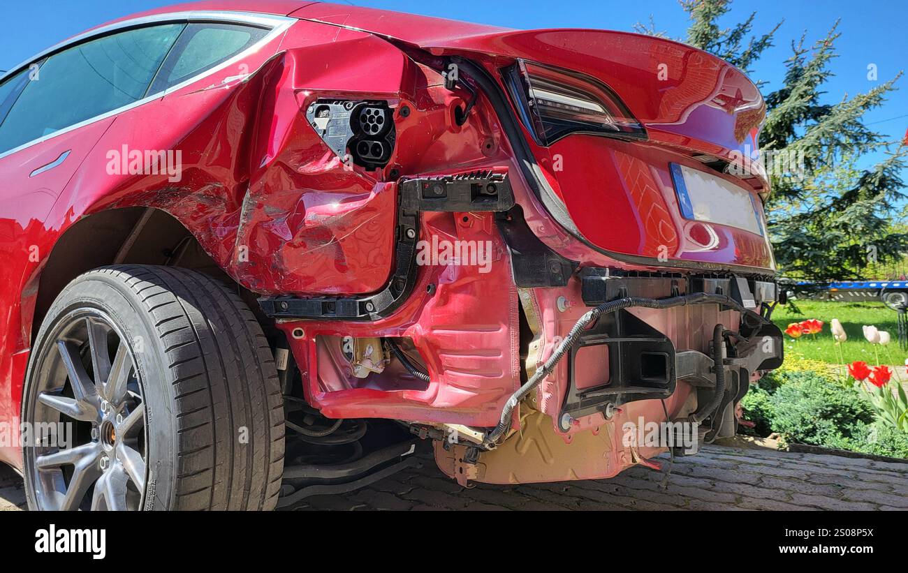 Close-up view of damage to red car after serious accident: damaged ...