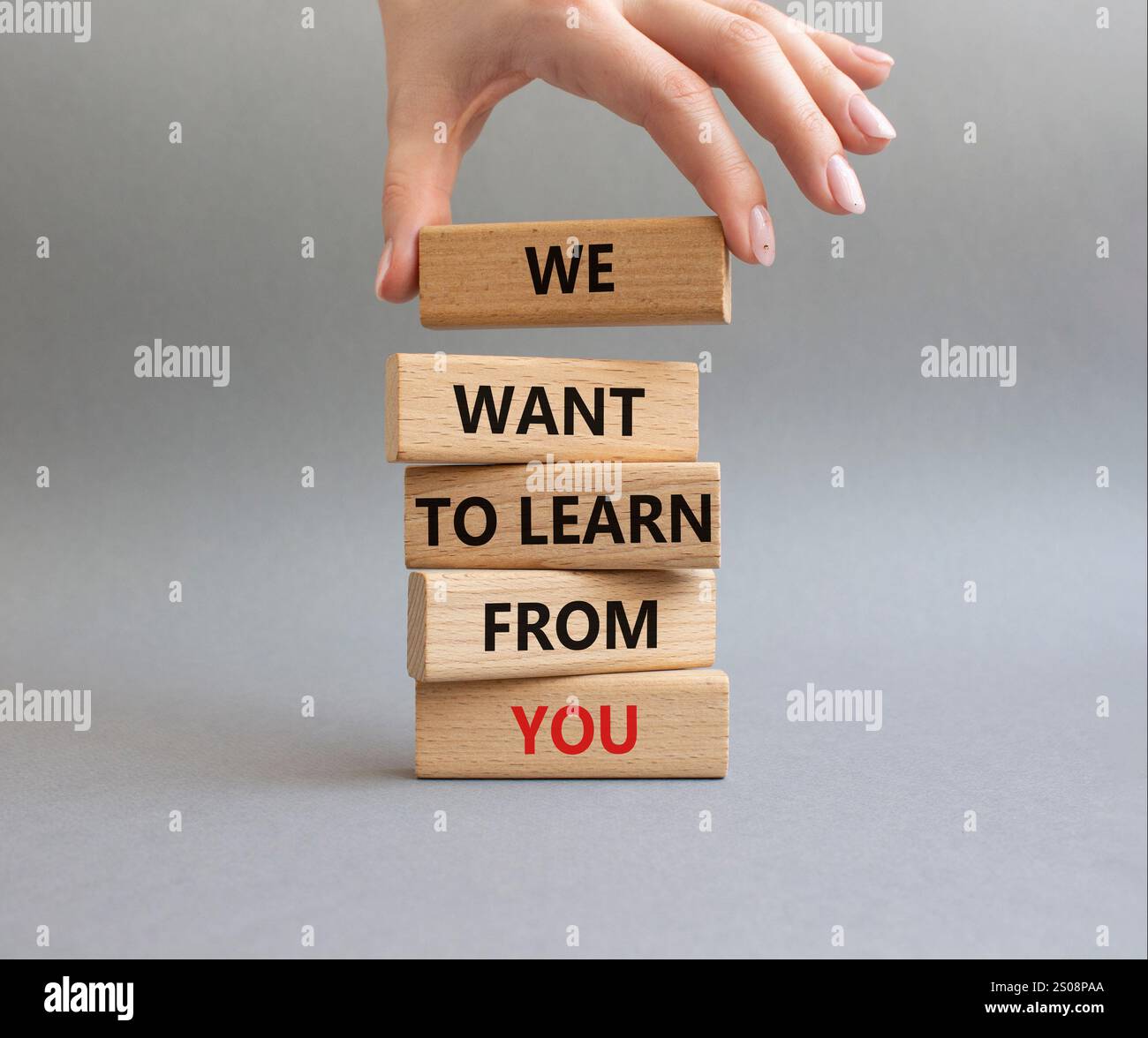 We want to learn from you symbol. Wooden blocks with words We want to ...