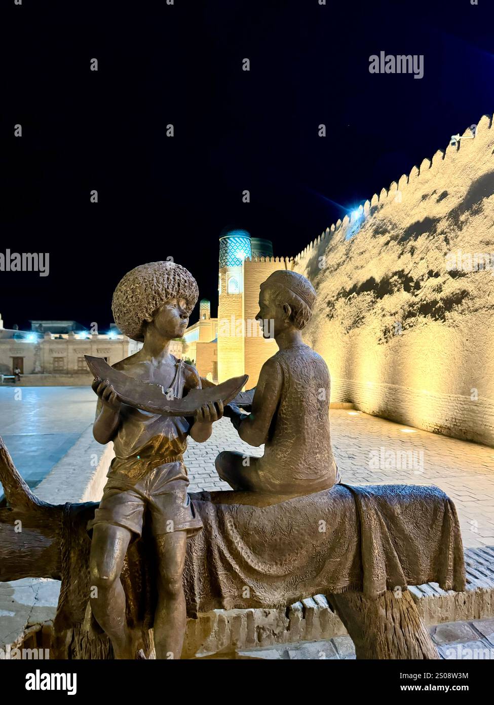 Bronze Statue of Children Sharing Melon in Historic Khiva Stock Photo ...