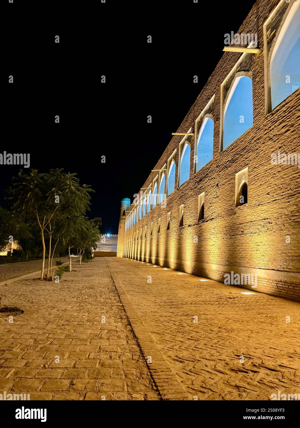 Illuminated Historic Wall with Arched Windows and Night Path Stock ...