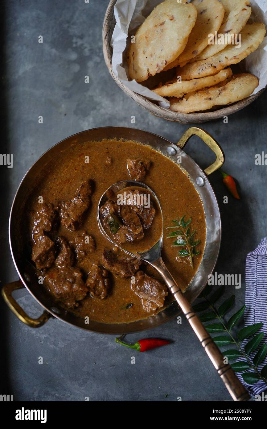Lamb curry served with Ney Pathal | Kerala breakfast meal Stock Photo ...
