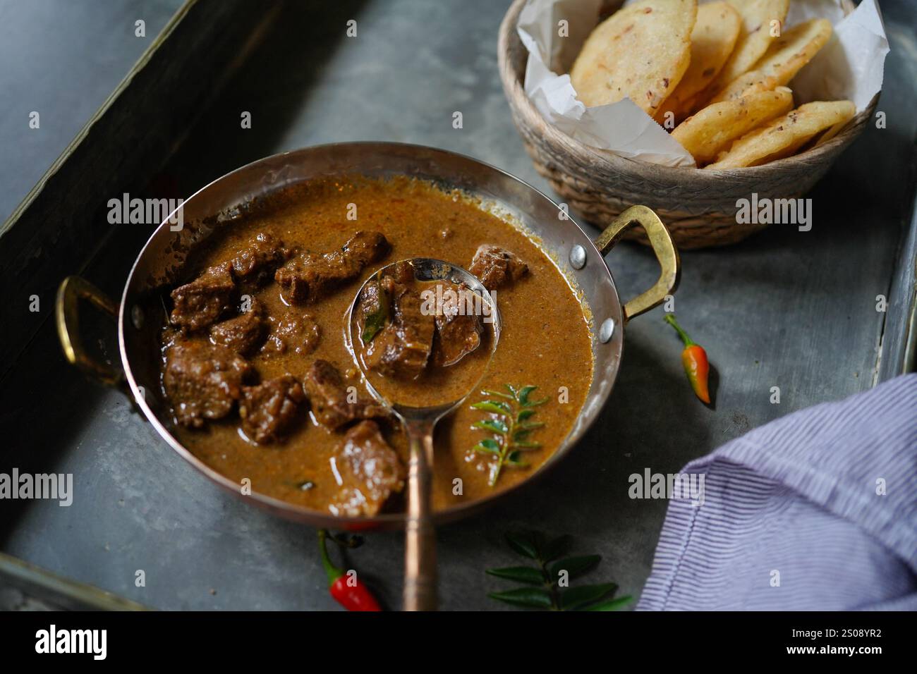 Lamb curry served with Ney Pathal | Kerala breakfast meal Stock Photo ...