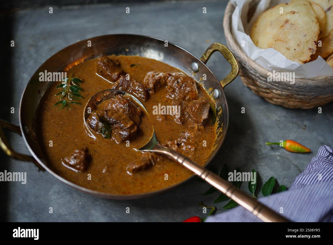 Lamb curry served with Ney Pathal | Kerala breakfast meal Stock Photo ...