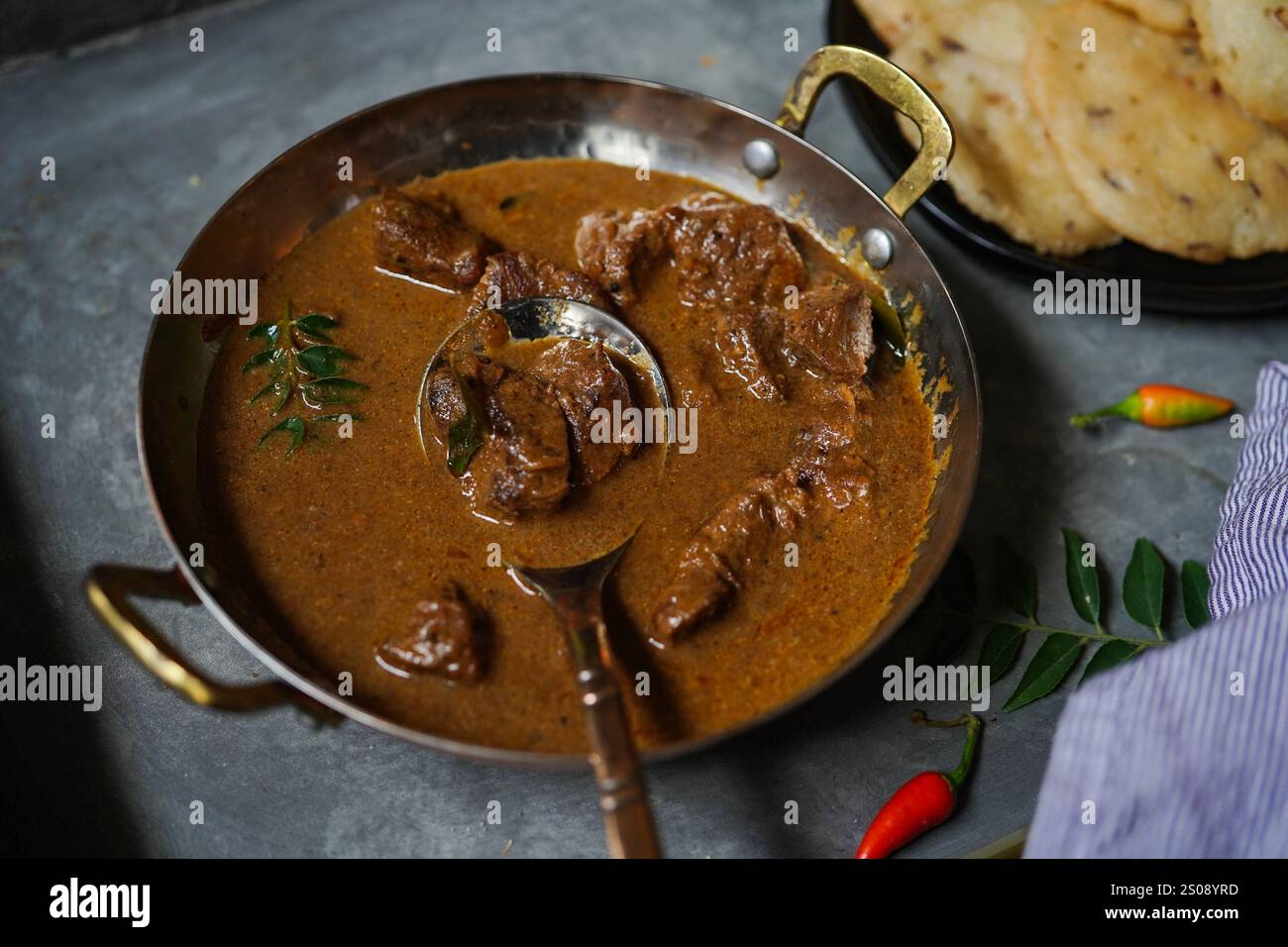 Lamb curry served with Ney Pathal | Kerala breakfast meal Stock Photo ...