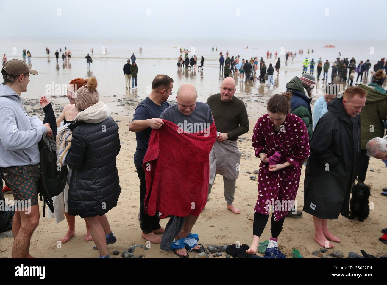 December 26, 2024, Cromer, England, UK: Swimmers get changed into warm ...