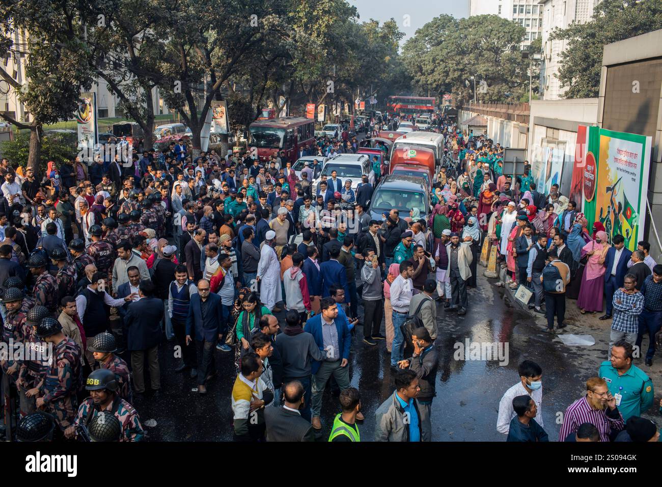 Dhaka, Bangladesh. 26th Dec, 2024. A crowd of people gathers around the ...
