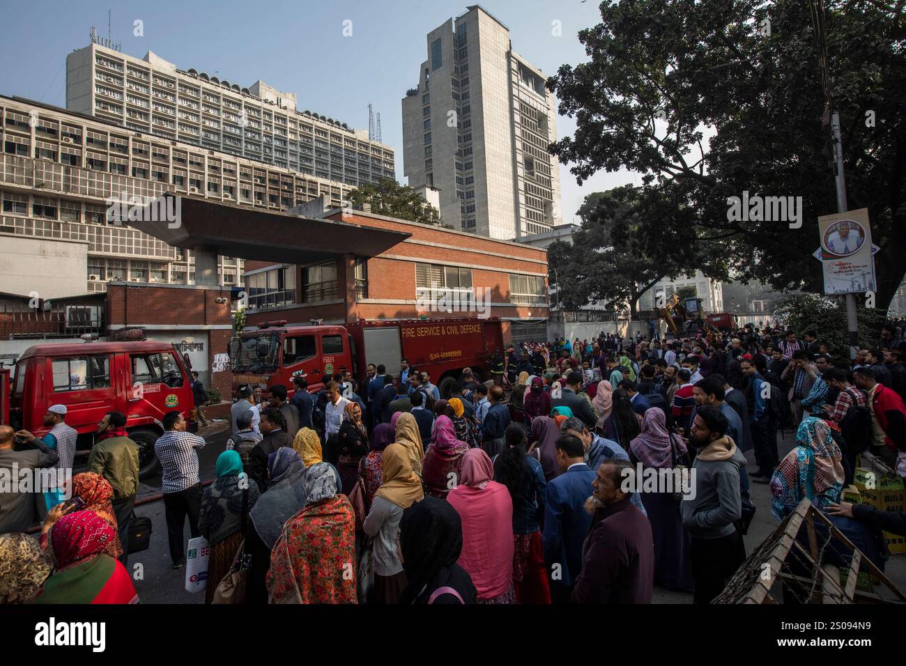 Dhaka, Bangladesh. 26th Dec, 2024. A crowd of people gathers around the ...