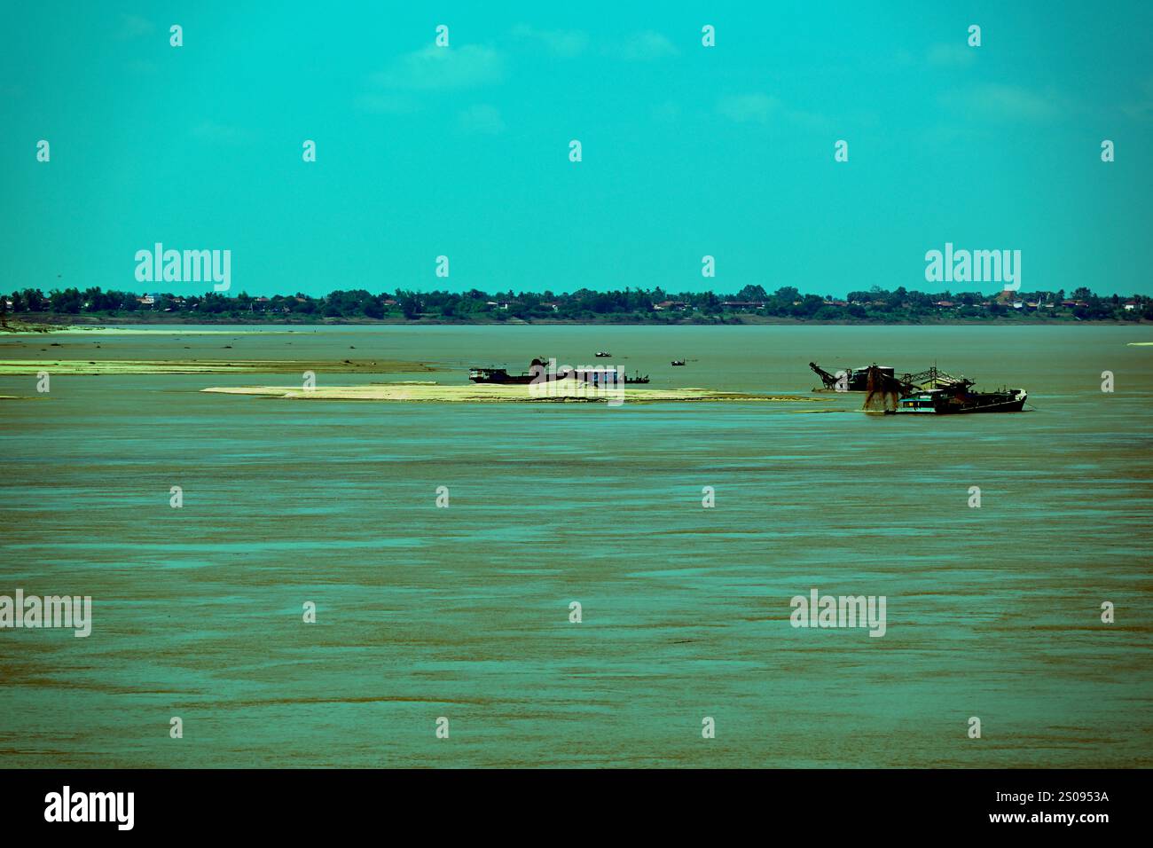 Stationary boats dredge sand from the Mekong riverbed for construction ...