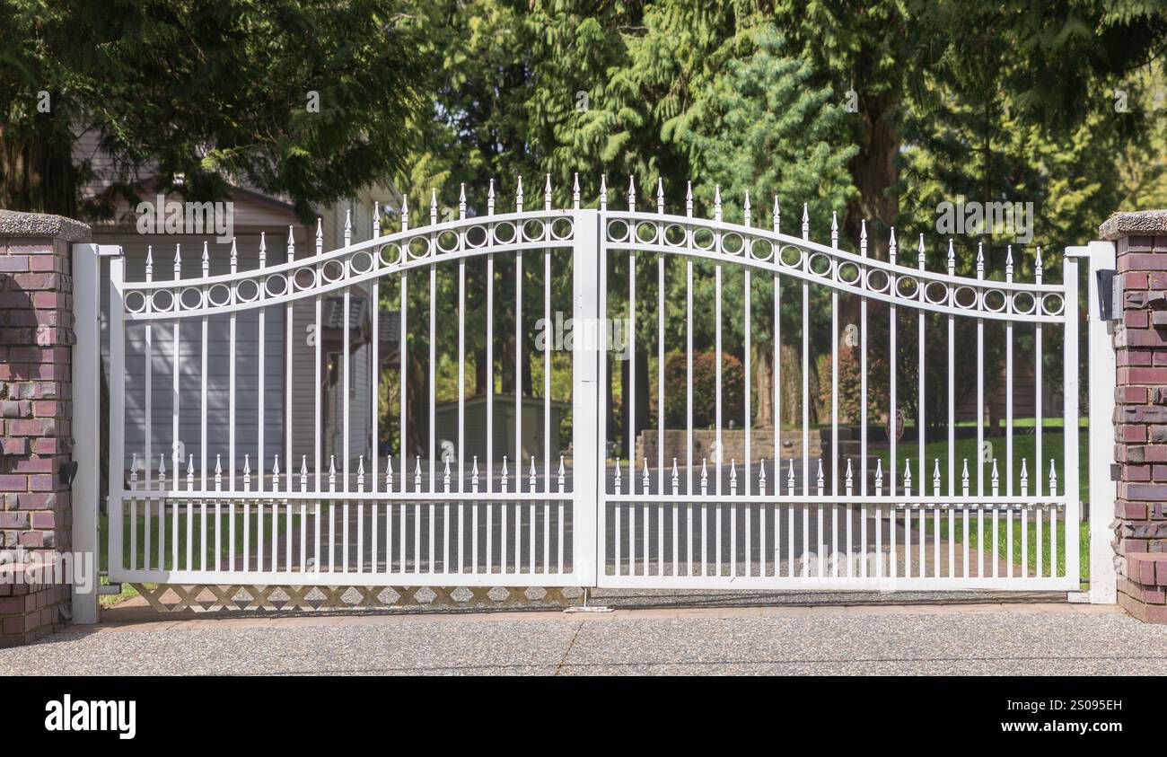 Metal white fence gate of a luxury home. Heavy duty metal front gate ...