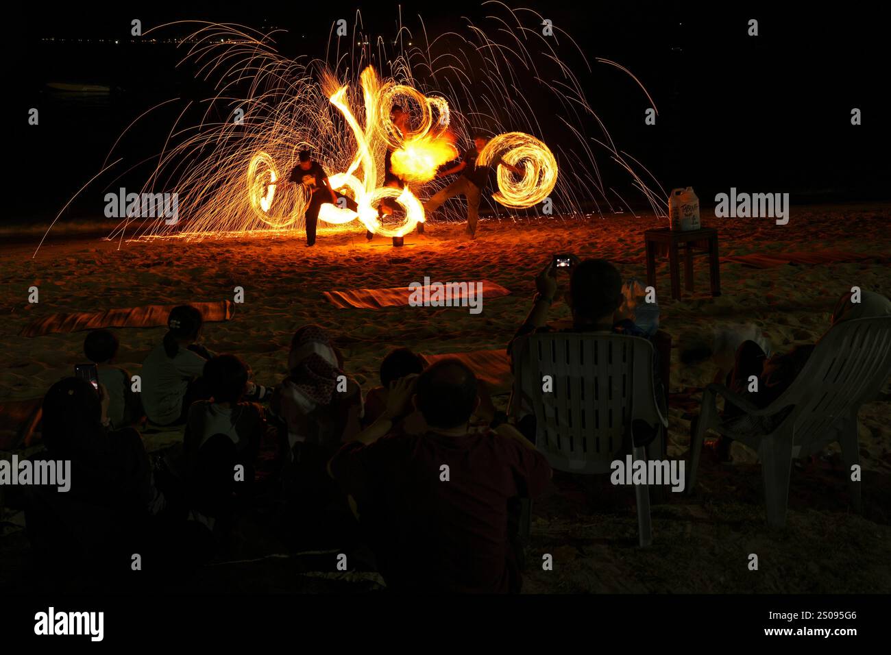 Visitors watch Malay artists perform a fire sparkling performance on a ...