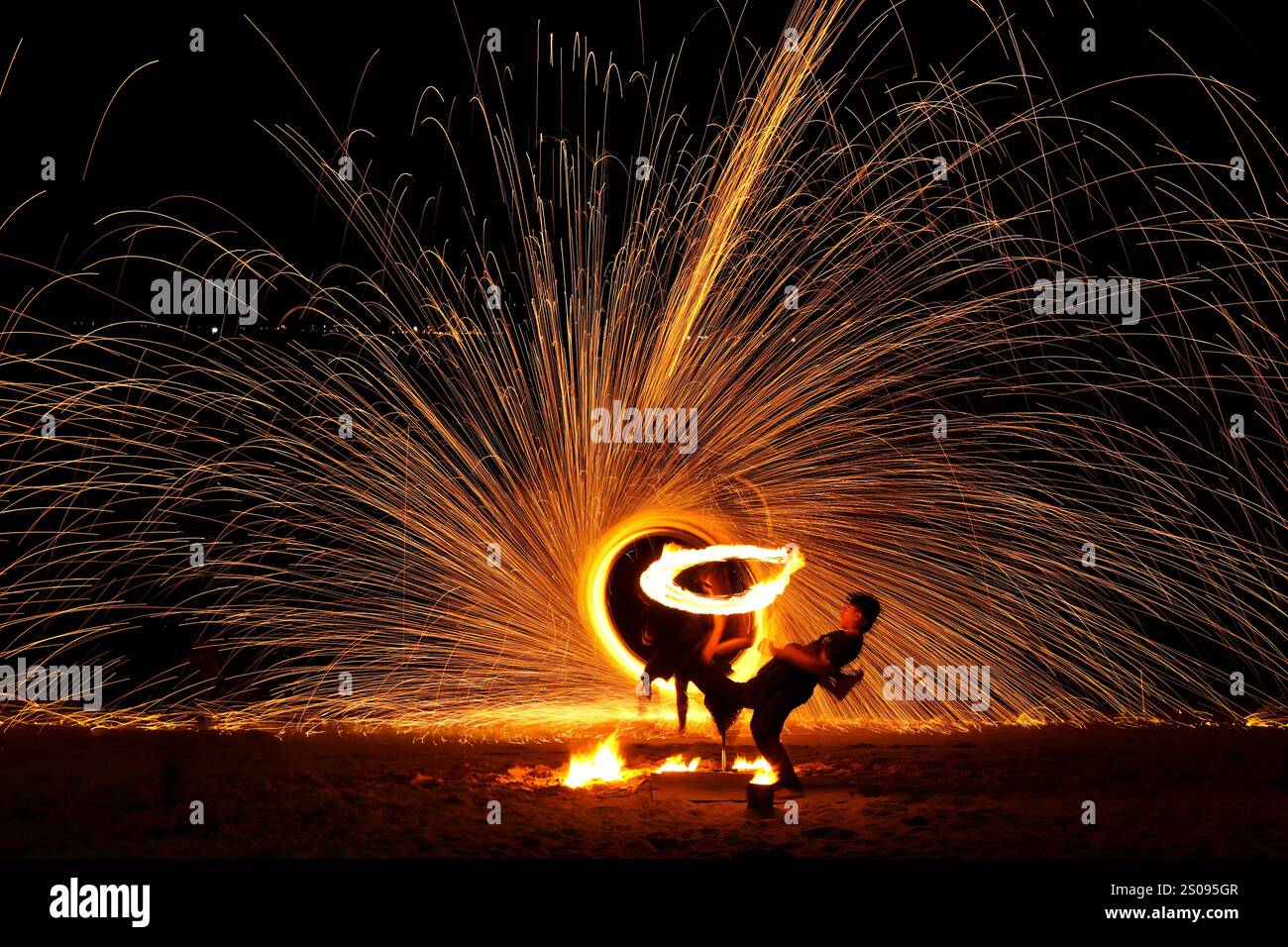 Malay artists perform a fire sparkling performance on a beach side ...