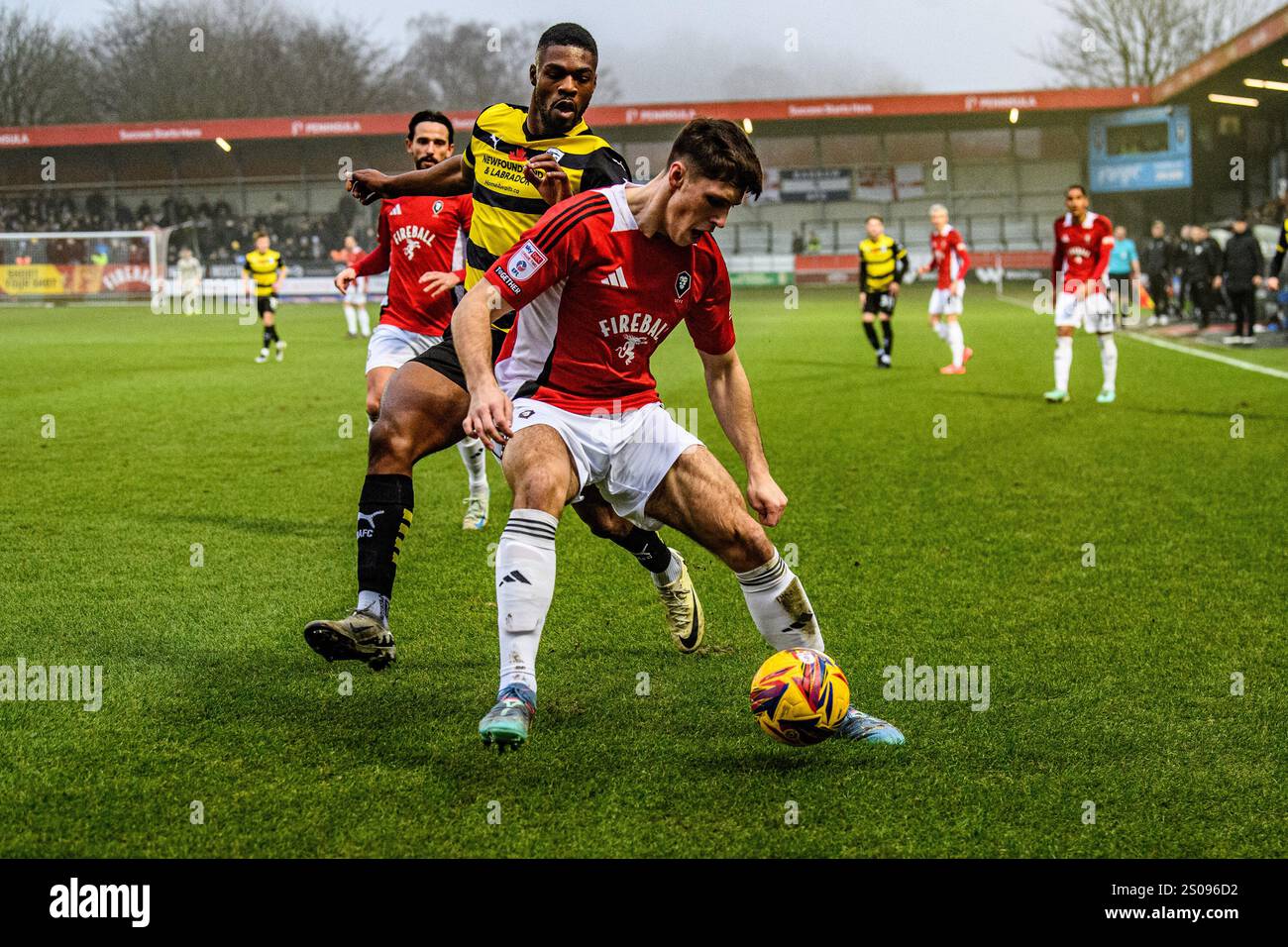 Salford, UK. 26th Dec 2024. Stephen Negru of Salford City FC holds off ...