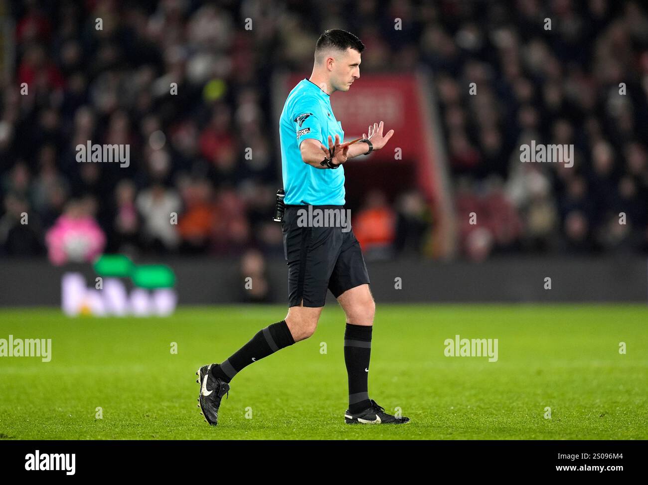 Referee Lewis Smith rescinds a red card for West Ham United's Guido ...