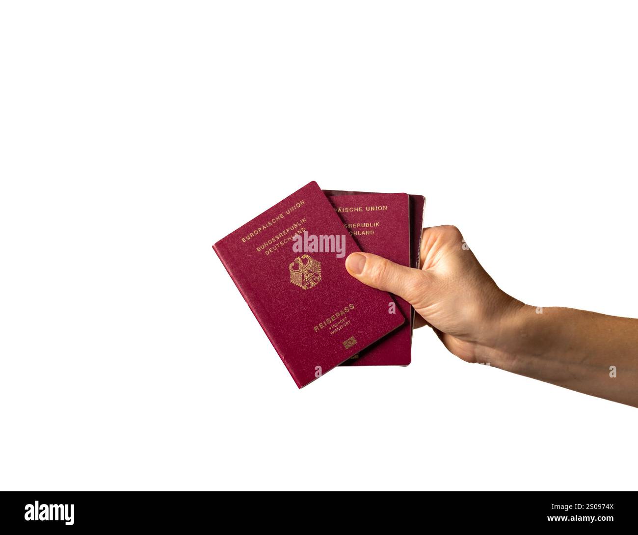 A close-up shot of a hand holding German passports, including a child's ...