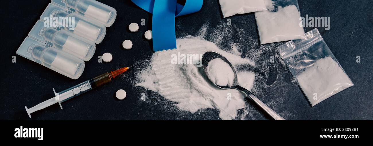 Drug addiction concept. Bags of heroin, tablets, ampoules and syringes ...