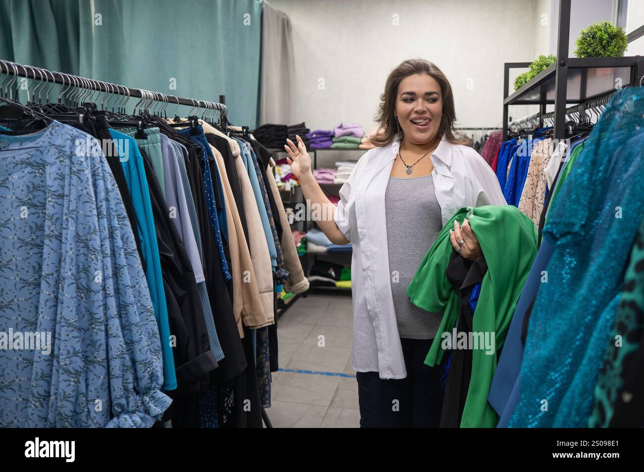 A fat woman chooses clothes in a plus size store Stock Photo - Alamy