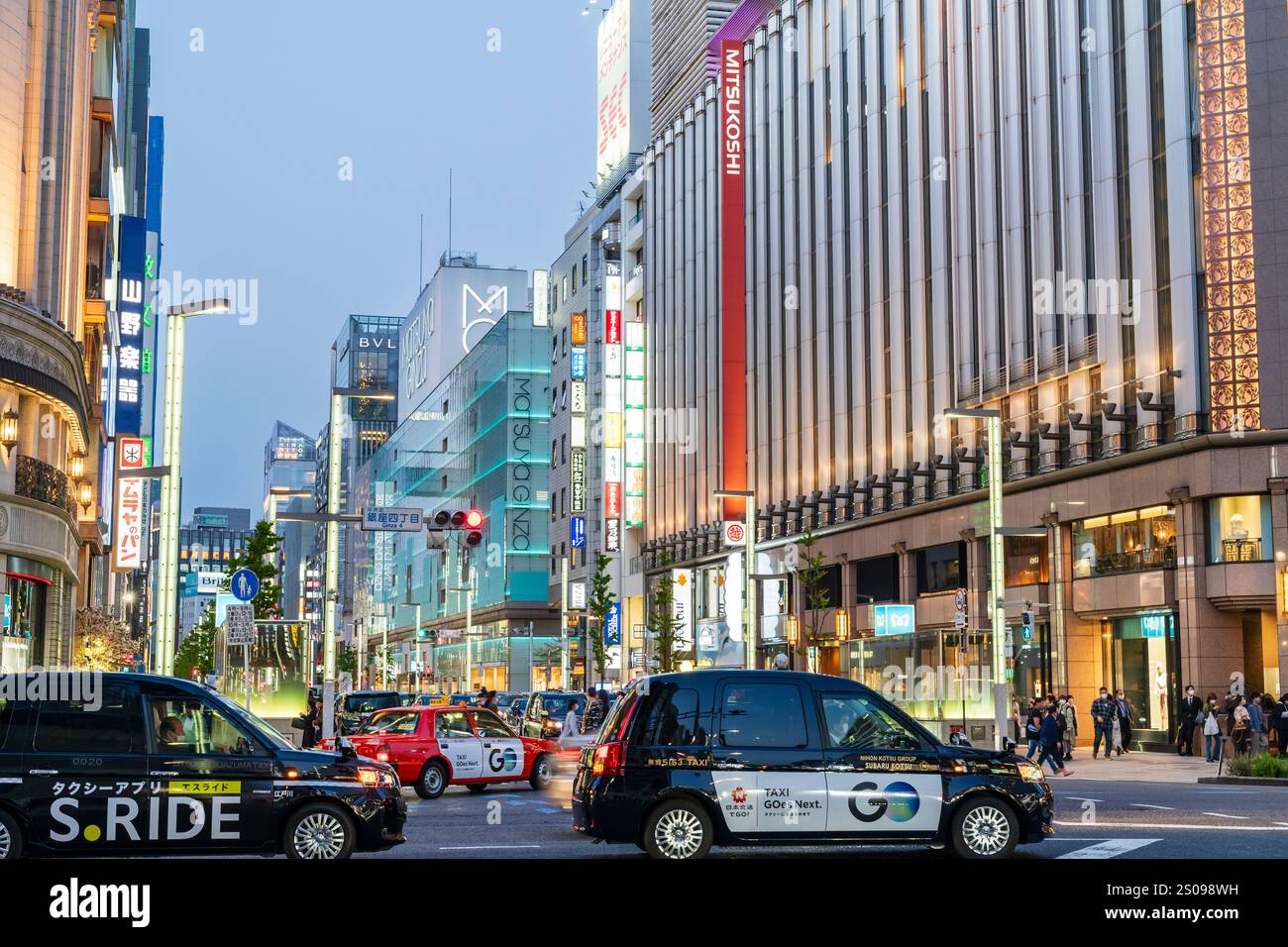 The Mitsukoshi and behind, the Matsuya Ginza Department store building at dusk. In front, the ...