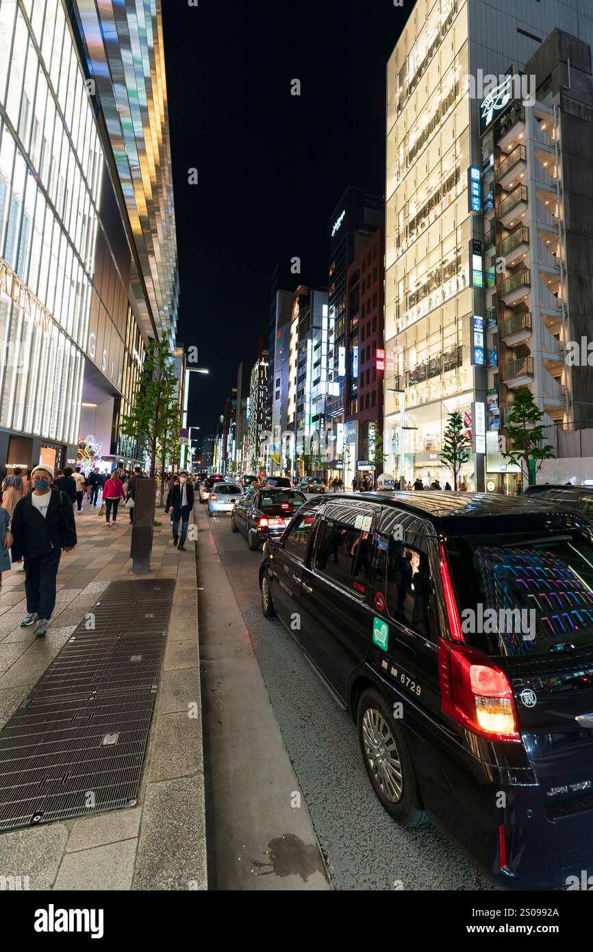 Pavement view along the famous Ginza at night by the G SIX building ...