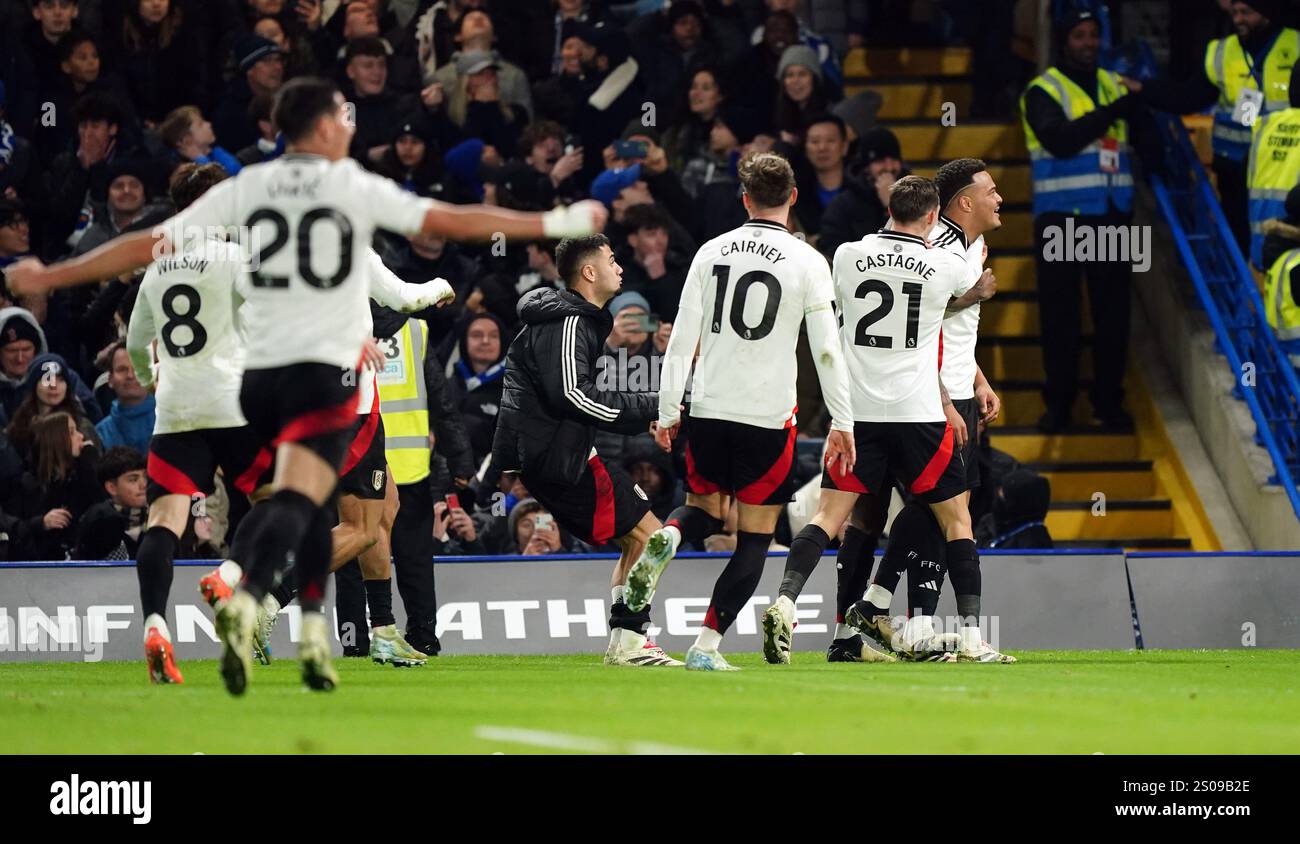 Fulham players celebrate with their fans after Rodrigo Muniz scored his ...