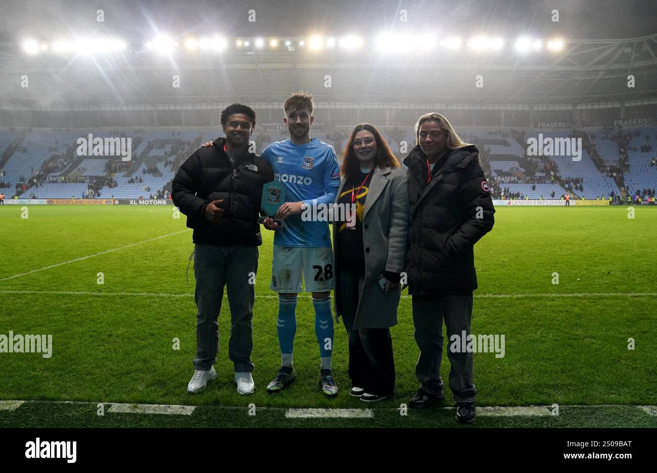 Coventry City's Josh Eccles (second left) is presented with his man of ...