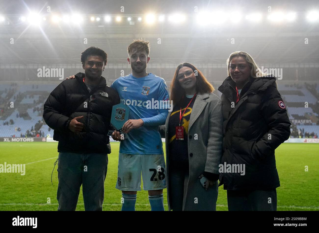 Coventry City's Josh Eccles (second left) is presented with his man of ...