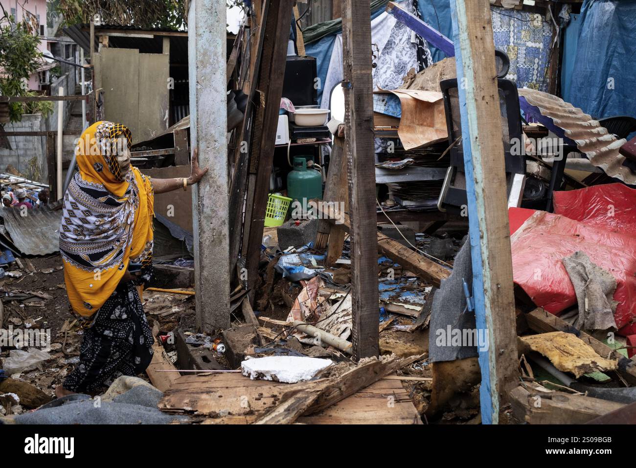 Mayotte. 24th Dec, 2024. A woman in the rubble of cyclone-damaged homes ...