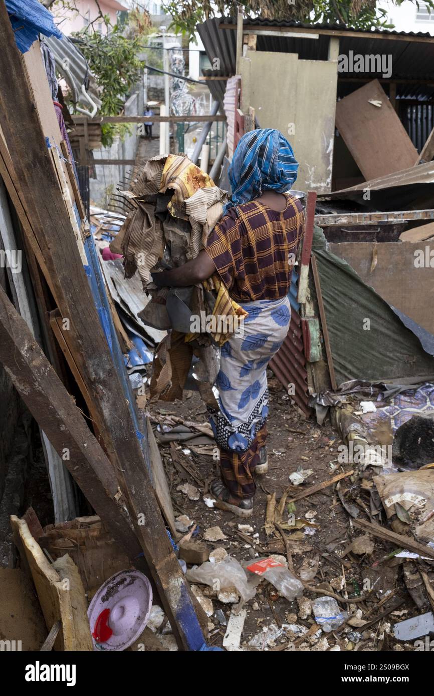 Mayotte. 24th Dec, 2024. A woman in the rubble of cyclone-damaged homes ...