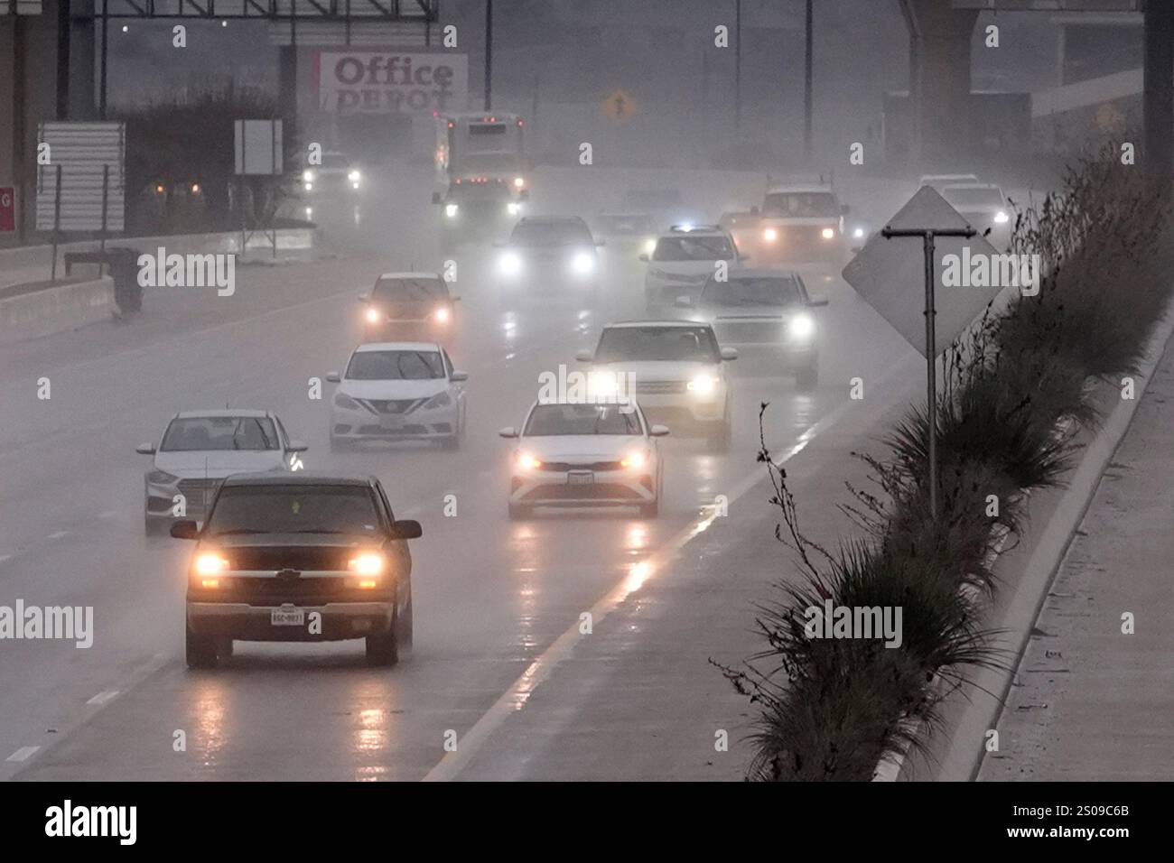 Vehicles make their way on a rain soaked highway in Dallas, Thursday ...