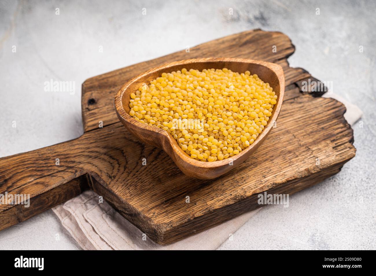 Dry Ptitim pasta, Israeli couscous in wooden bowl. white background ...
