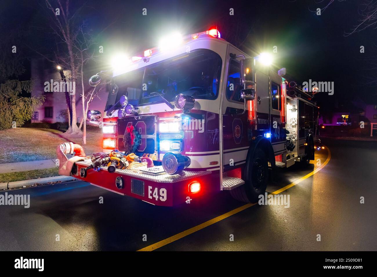 Close up emergency fire truck illuminated at night driving through ...