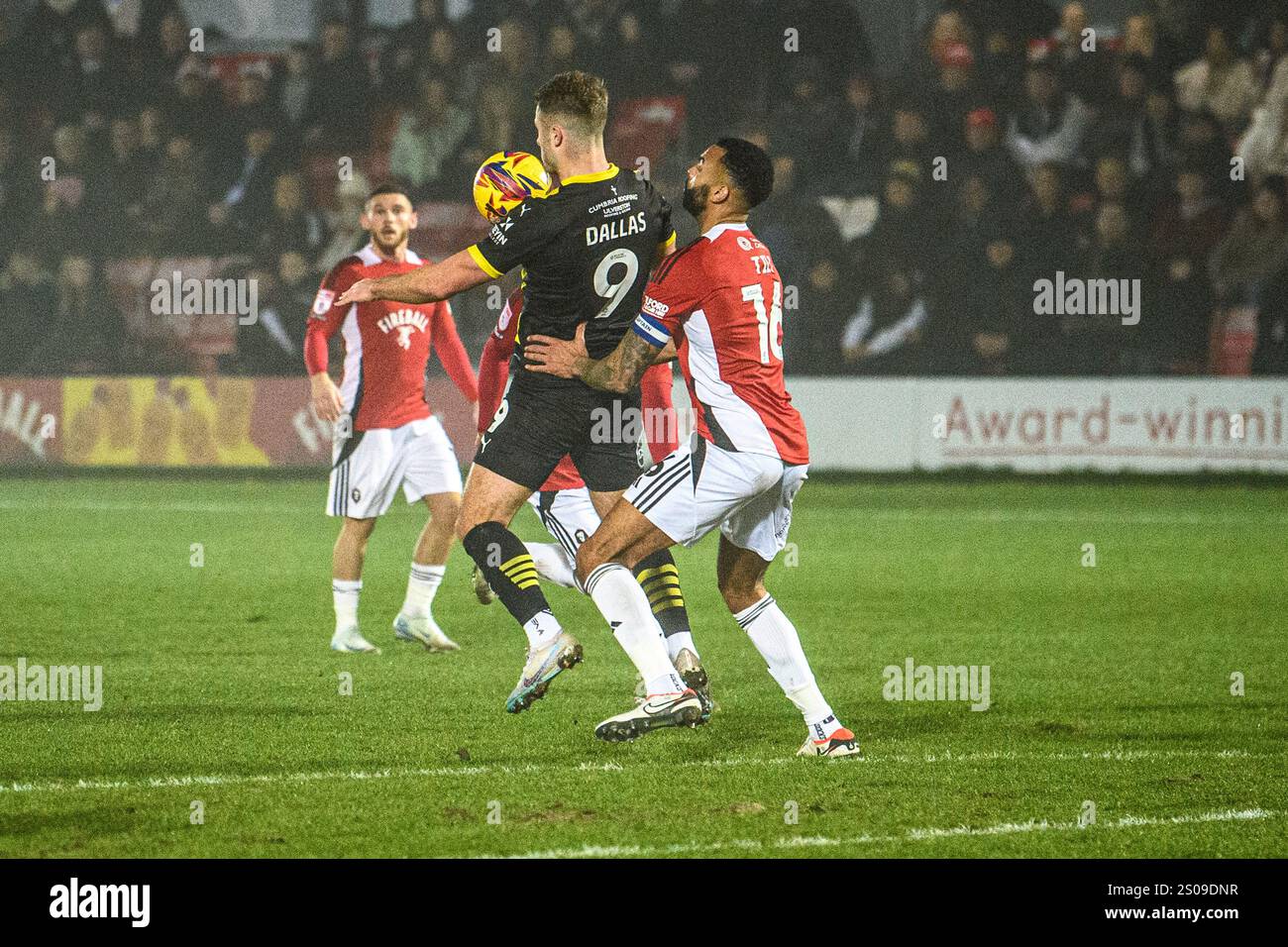Andrew Dallas of Barrow AFC under pressure from Curtis Tilt of Salford ...