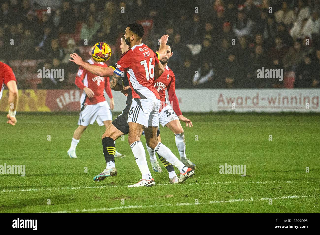 Andrew Dallas of Barrow AFC under pressure from Curtis Tilt of Salford ...