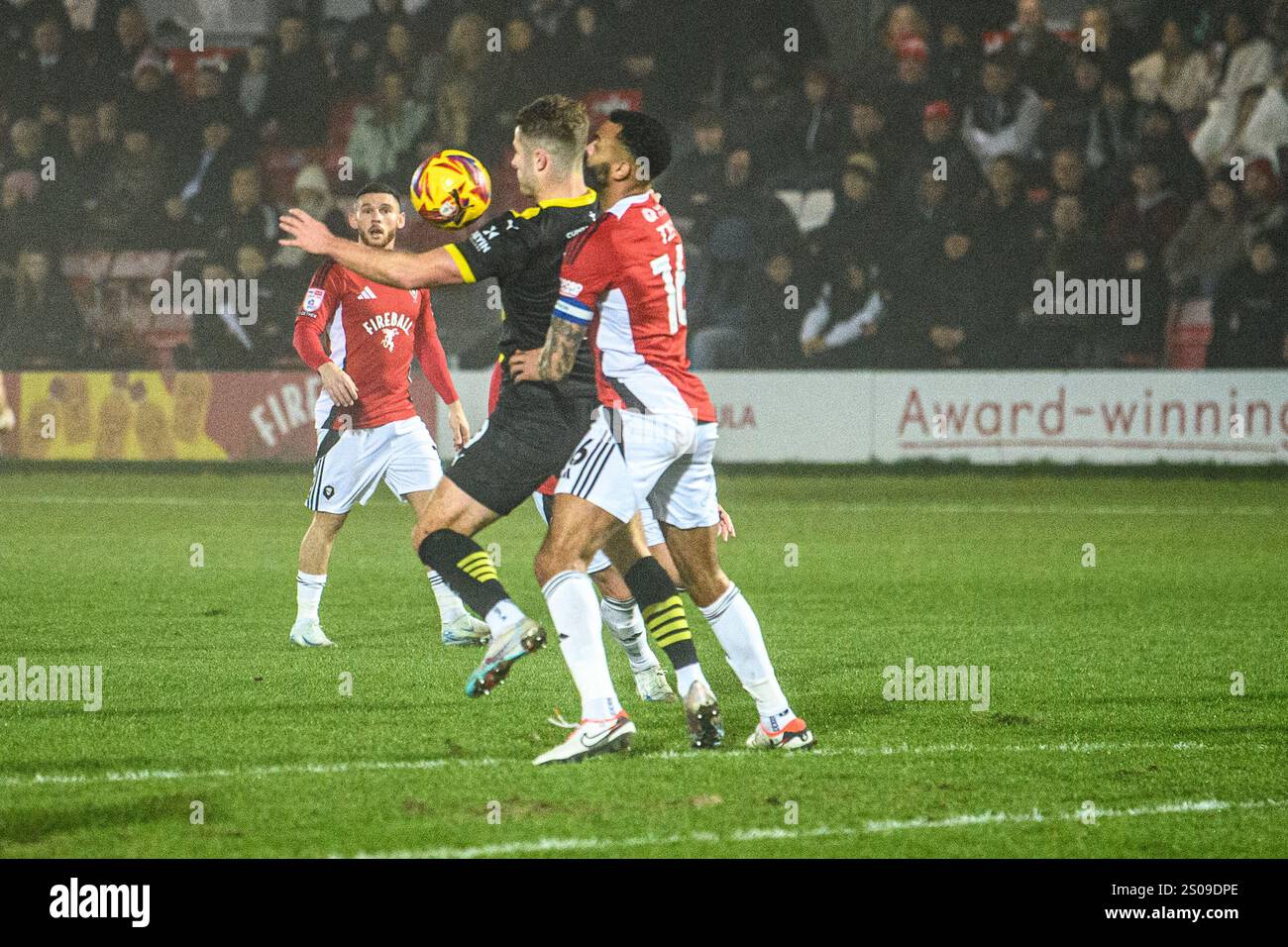 Andrew Dallas of Barrow AFC under pressure from Curtis Tilt of Salford ...
