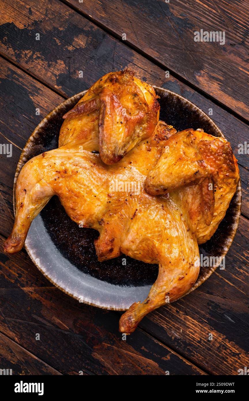 Baked chicken Tabaka Tobacco with spices, poultry meat on plate. wooden ...