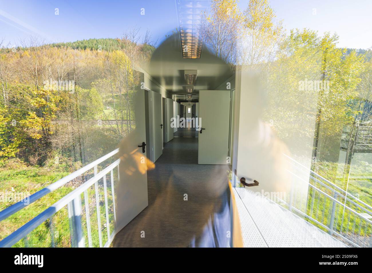 Reflection in the window shows the interior of the building and the ...