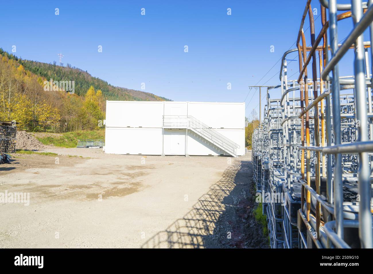 White buildings with metal cages and an open area in front of a ...