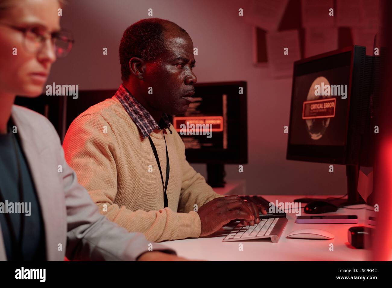 Mature African American male IT manager typing on computer keypad while ...